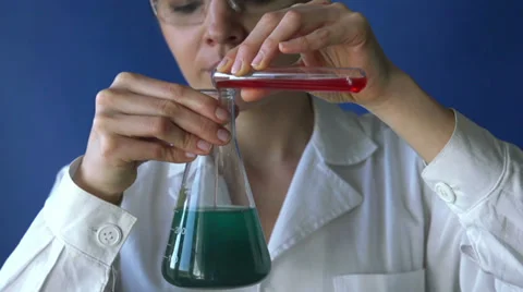 Scientist pouring chemicals into erlenme... | Stock Video | Pond5