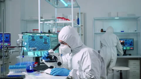 Scientist in ppe suit working in laborat... | Stock Video | Pond5