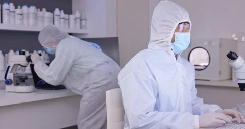Scientist team in laboratory, PPE and ty... | Stock Video | Pond5