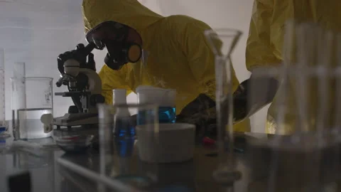 Scientists in Hazmat Suits Collaborating... | Stock Video | Pond5