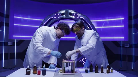 Scientists mixing liquids in lab tubes w... | Stock Video | Pond5