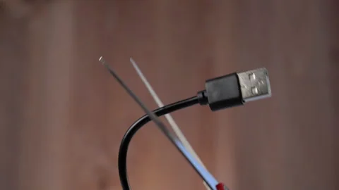 Scissors cutting black USB cable close u... | Stock Video | Pond5