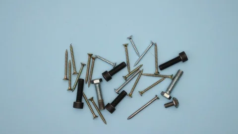 Screws moving around on blue background ... | Stock Video | Pond5