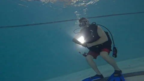Scuba diver training in pool being silly... | Stock Video | Pond5