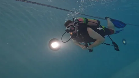 Scuba diver training in swimming pool fo... | Stock Video | Pond5