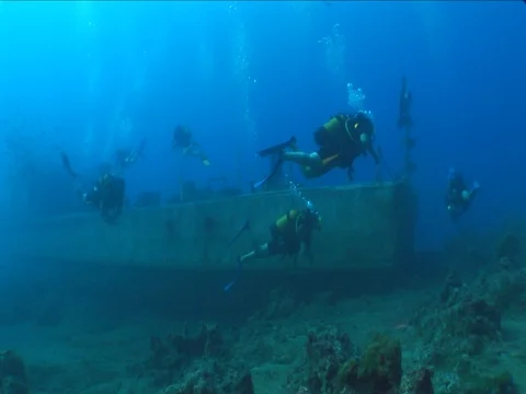 scuba divers exploring the ship wreck un... | Stock Video | Pond5