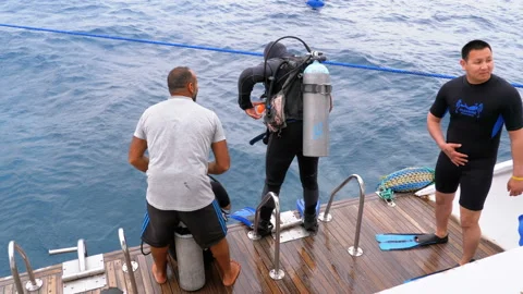 Scuba Divers getting ready to jump off t... | Stock Video | Pond5
