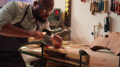Sculptor shaping raw timber using chisel... | Stock Video | Pond5