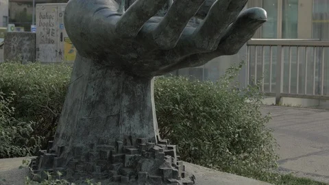 Sculpture of a hand holding a tower | Stock Video | Pond5
