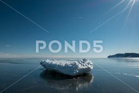 Sea ice with blue sky and sunray background ~ Premium Photo #86291194