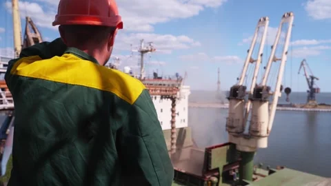 Sea port worker looking at wheat loading... | Stock Video | Pond5