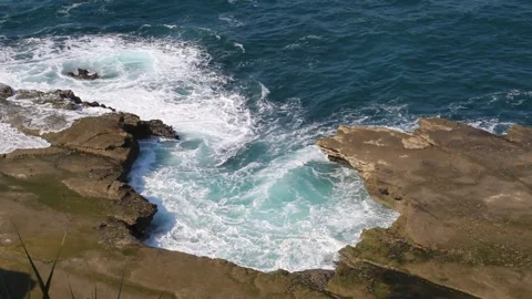 Sea waves hit the sea stack and create s... | Stock Video | Pond5