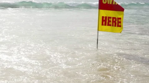 Sea waves, red flag | Stock Video | Pond5