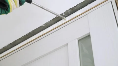Sealing the opening between the door fra... | Stock Video | Pond5