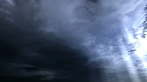 Seamless loop of storm clouds with rays.... | Stock Video | Pond5