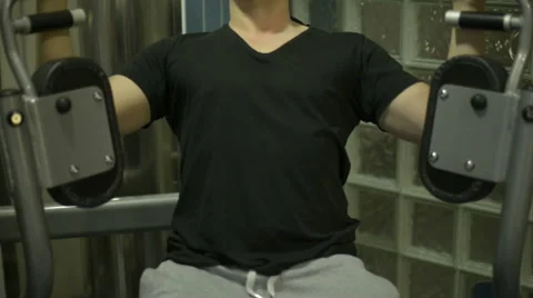 Seated butterfly pec deck exercise | Stock Video | Pond5