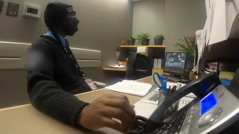 Security guard at front desk | Stock Video | Pond5