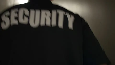 Security guard patrolling on stairs insi... | Stock Video | Pond5