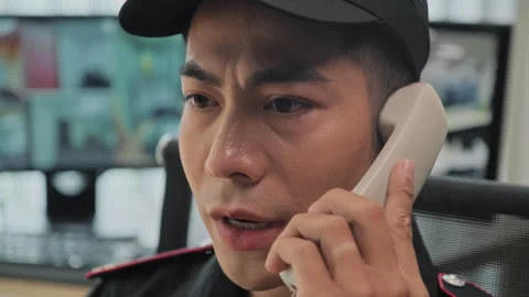 Security Guard Talking on Phone while Si... | Stock Video | Pond5