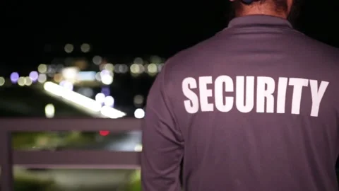 Security guard is watching over city lig... | Stock Video | Pond5