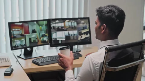 Security Man Looking at CCTV Cameras at ... | Stock Video | Pond5