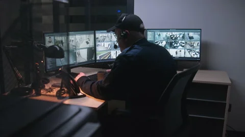 Security operator in headset controls CC... | Stock Video | Pond5