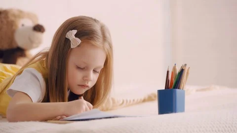 Selective focus of kid drawing on bed | Stock Video | Pond5