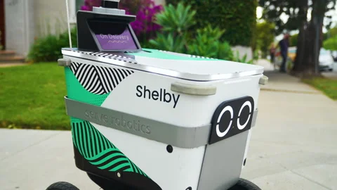 Self-driving robot delivering package | Stock Video | Pond5