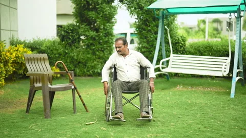 Seniar man sit on wheelchair wander gard... | Stock Video | Pond5