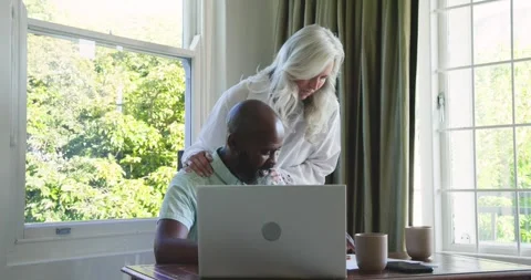 Senior couple typing on laptop at dining... | Stock Video | Pond5