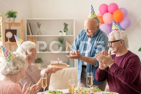 Senior friends clapping hands to their friend with birthday cake Stock ...