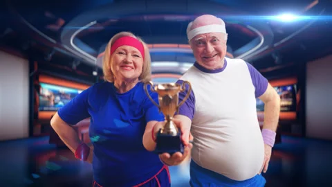 Senior game show winners showing gold cu... | Stock Video | Pond5