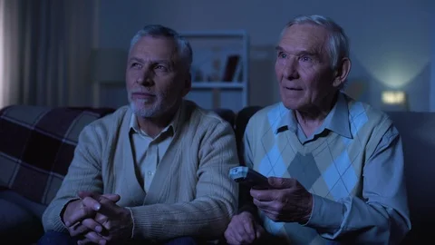 Senior male friends switching channels, ... | Stock Video | Pond5