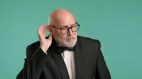Senior Man with Hand Behind Ear, Teal Ba... | Stock Video | Pond5