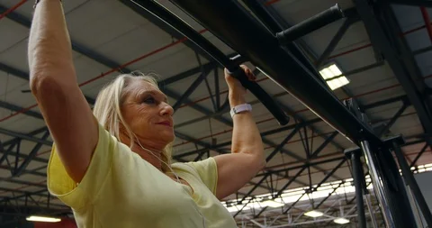 Senior woman doing pull-ups in fitness s... | Stock Video | Pond5