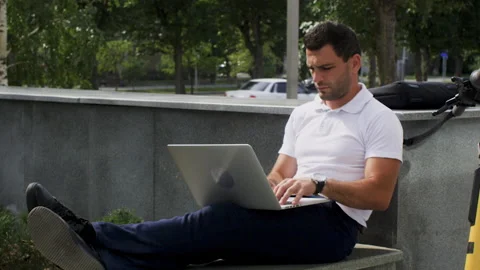 Serious busy man sitting on curb in city... | Stock Video | Pond5