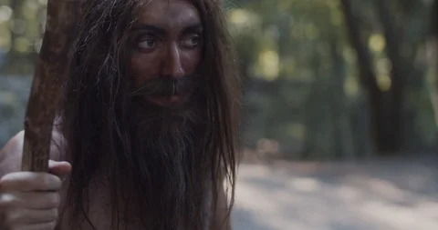 Serious caveman holding weapon neanderth... | Stock Video | Pond5