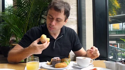 Serious man eating, biting with his mout... | Stock Video | Pond5