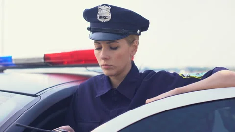 Serious police woman receiving call on r... | Stock Video | Pond5