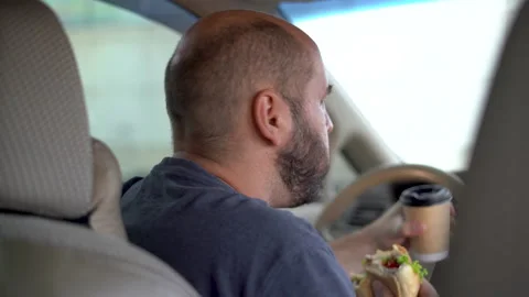 Serious tired man eating fast food and d... | Stock Video | Pond5