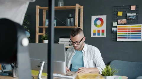 Serious young man drawing logo symbols w... | Stock Video | Pond5