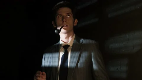 serious young man lights his pipe with a... | Stock Video | Pond5