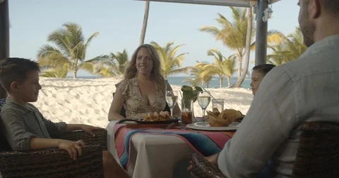 Server Brings Meal to Family at Beach Re... | Stock Video | Pond5