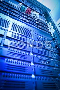 Server rack cluster in a data center (shallow DOF; color toned i ...