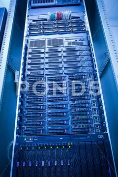 Server rack cluster in a data center (shallow DOF; color toned i ...