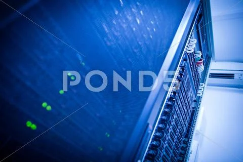 Photograph: Server rack cluster in a data center (shallow DOF; color ...