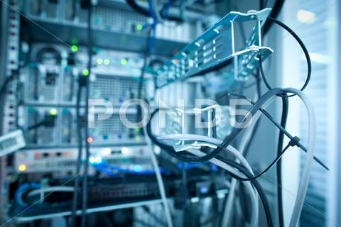 Server rack cluster in a data center (shallow DOF; color toned i ...