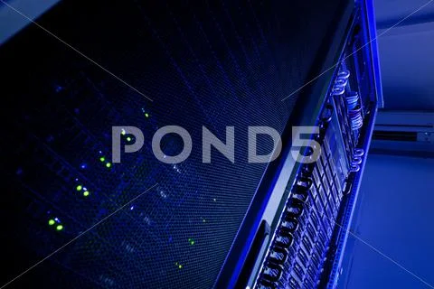 Server rack cluster in a data center (shallow DOF; color toned i ...