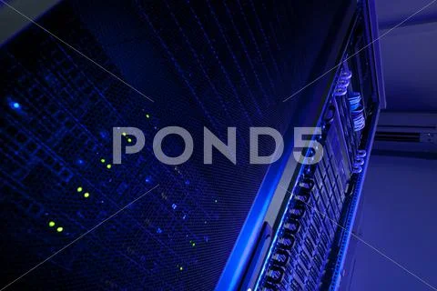 Server rack cluster in a data center (shallow DOF; color toned i ...