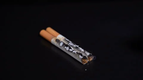 Set fire to a cigarette on a black backg... | Stock Video | Pond5